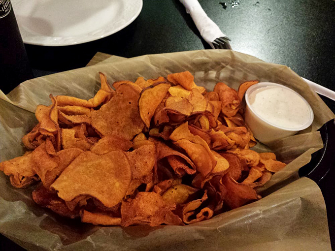 House-made sweet potato chips that shatter with each bite—the perfect vehicle for that creamy dipping sauce.
