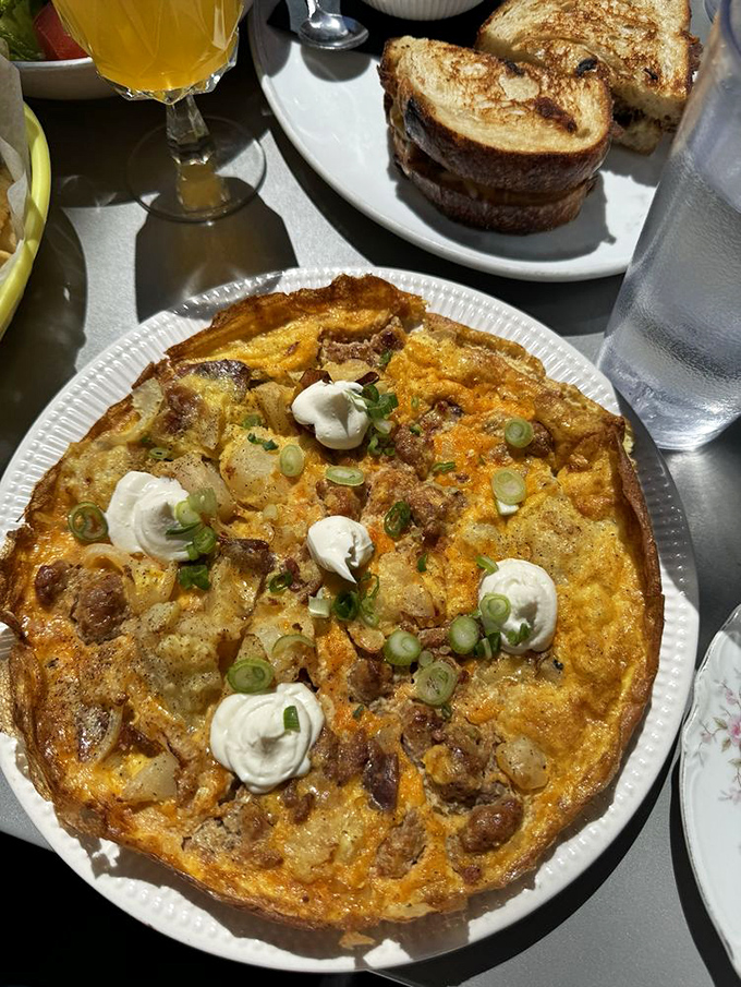 This potato frittata is what breakfast dreams are made of&mdash;a golden canvas of eggs, potatoes, and cheese topped with dollops of sour cream.