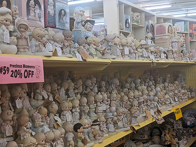 The Precious Moments figurines section: where wide-eyed porcelain children silently judge your life choices from their pastel perches.