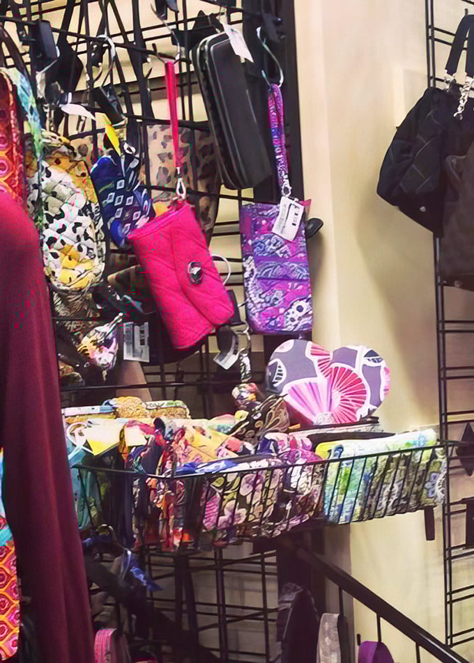 Accessory nirvana exists, and it's this wall of colorful clutches and wallets that whisper, "You need me for that wedding next month."