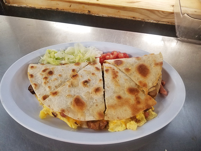 A quesadilla that doesn't skimp on the filling—where the cheese stretches dramatically with each bite like it's auditioning for a food commercial.