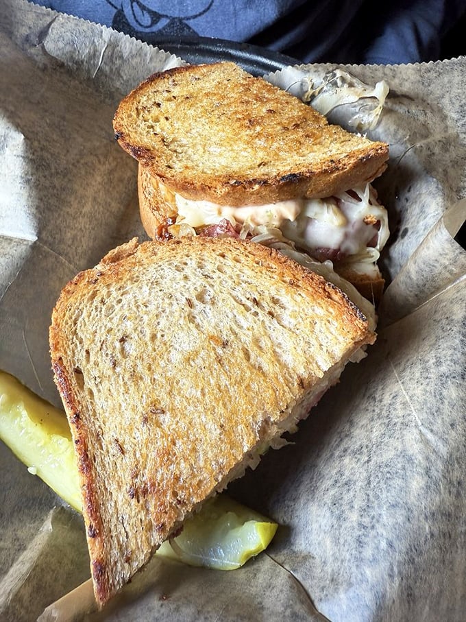 A Reuben sandwich that's achieved perfect balance: toasty bread, melty cheese, and enough corned beef to make your cardiologist write a strongly worded letter.