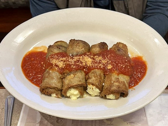 Rolled eggplant parmesan that proves vegetables can be just as indulgent as any meat dish when properly introduced to cheese and sauce.
