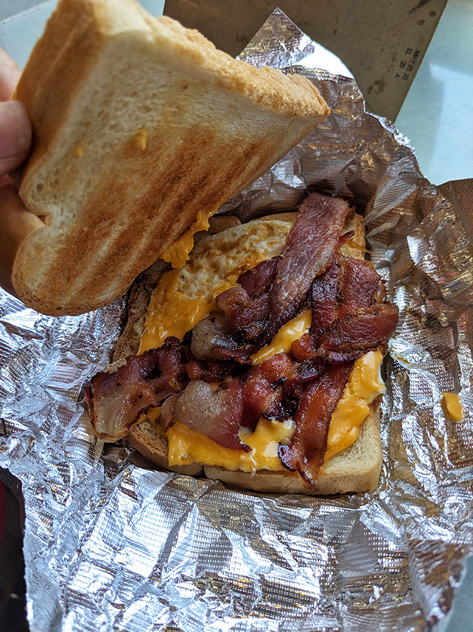 Breakfast sandwich engineering at its finest. Melty cheese, crispy bacon, and golden toast – the holy trinity of morning salvation.