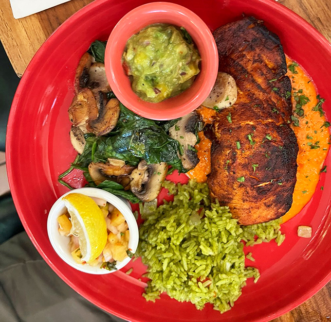 A plate so colorful it could double as modern art&mdash;blackened salmon resting on a bed of vibrant green rice with mushrooms playing supporting roles.