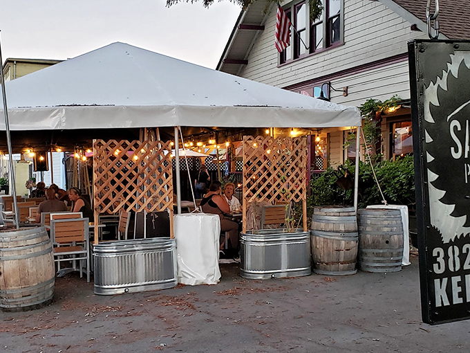 Outdoor dining with string lights and wine barrels&mdash;because food always tastes better with fresh air and the absence of big-city parking anxiety.