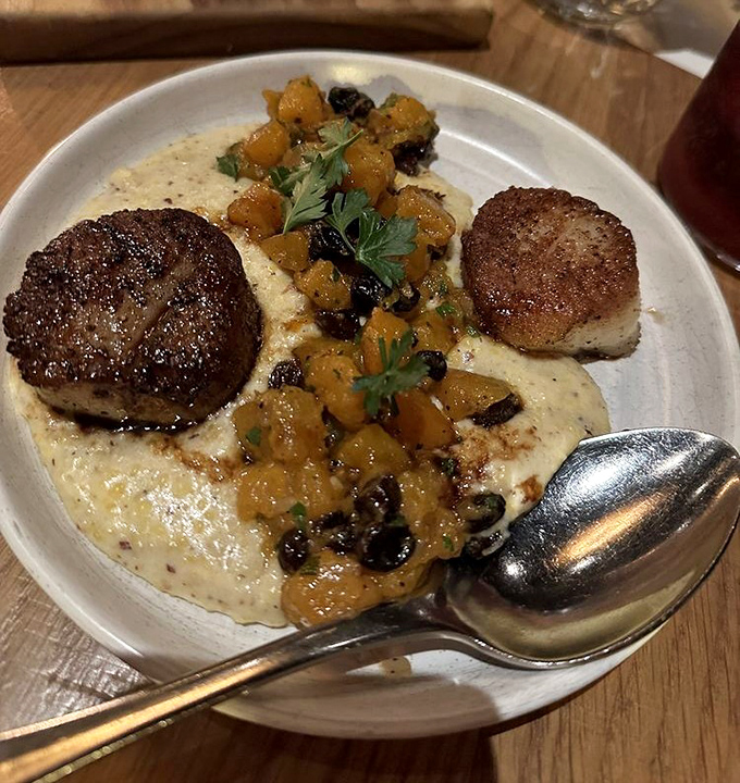 These scallops aren't just seared &ndash; they're transformed into golden medallions atop a creamy canvas of pure comfort.