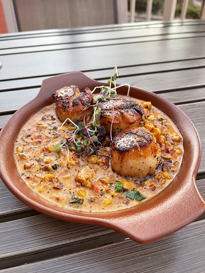 Seared scallops that could make a mermaid weep—caramelized to perfection and swimming in a corn-studded sauce that tastes like summer in Florida.