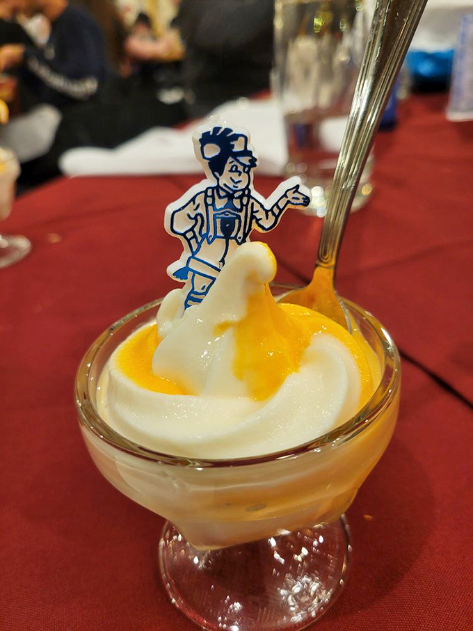 This isn't just dessert&mdash;it's a diplomatic summit between ice cream and fruit, with a little Bavarian mascot mediating the delicious negotiations.