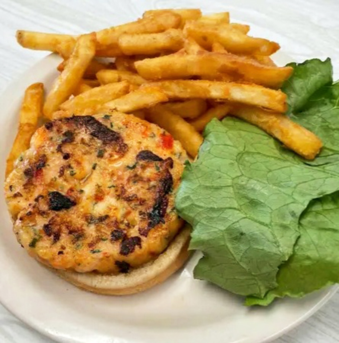 This isn't just a sandwich—it's seafood elevated to art form, with fries that deserve their own fan club.