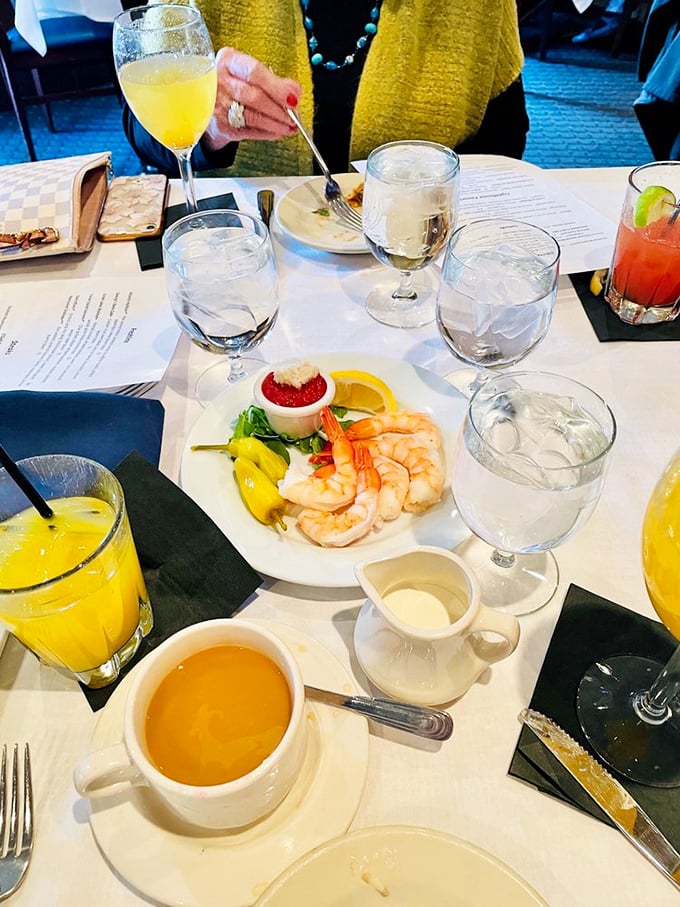 Pristine shrimp perched on the edge of cocktail sauce &ndash; like synchronized swimmers taking a break at the pool's edge, waiting for their moment.