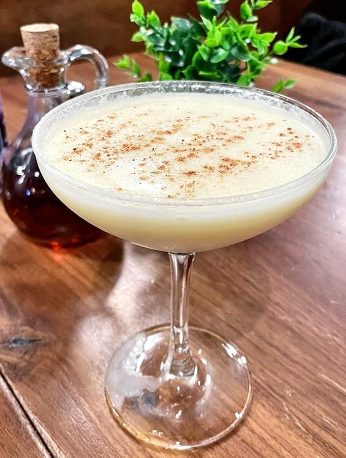This elegant cocktail proves Southern sophistication comes in liquid form too—a creamy concoction dusted with spice that whispers, "Sit a spell."