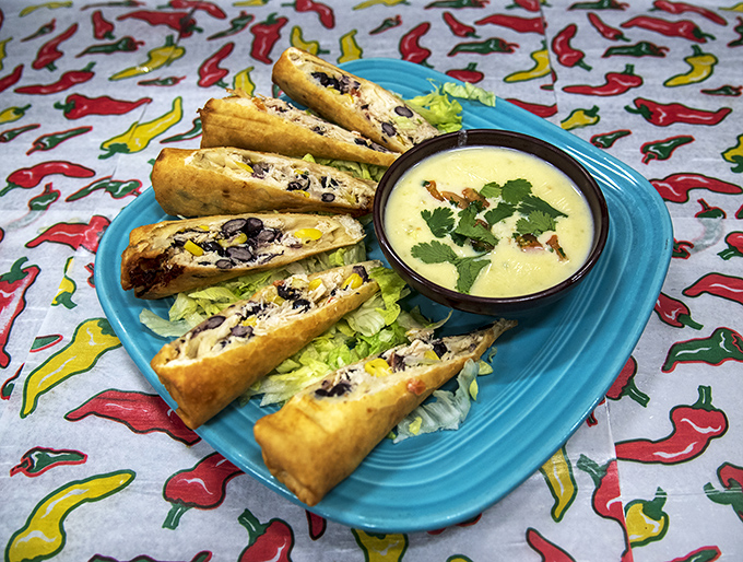 Southwestern egg rolls: where cultures deliciously collide on a turquoise plate, with a creamy dipping sauce that deserves its own fan club.