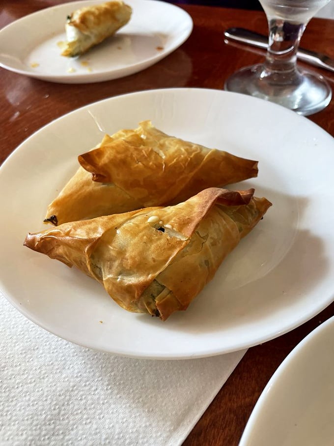 These triangles of phyllo-wrapped goodness aren't just appetizers&mdash;they're edible envelopes delivering messages of spinach and cheese directly to your soul.