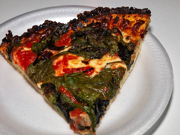 Spinach and sausage create a beautiful marriage on this slice, proving that sometimes opposites really do attract, especially in pizza form.