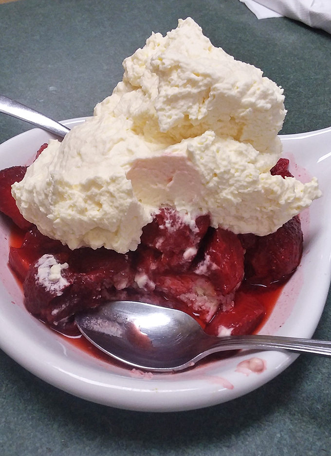 Fresh strawberries swimming beneath a cloud of whipped cream. Desserts like this make you wonder why anyone bothers with complicated pastry architecture.