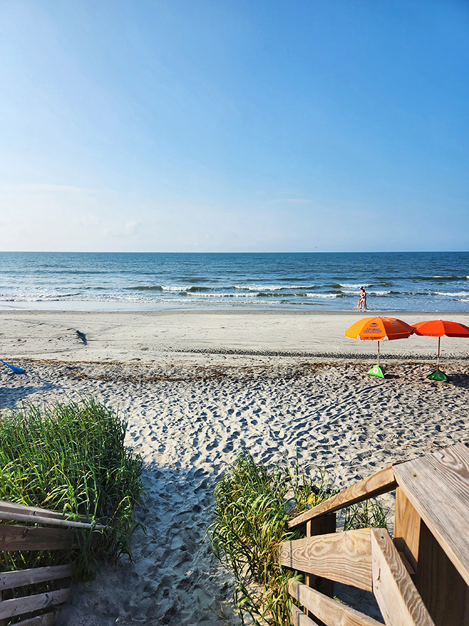 Colorful umbrellas dot pristine sand like confetti &ndash; nature's celebration where every day feels like a well-deserved vacation.