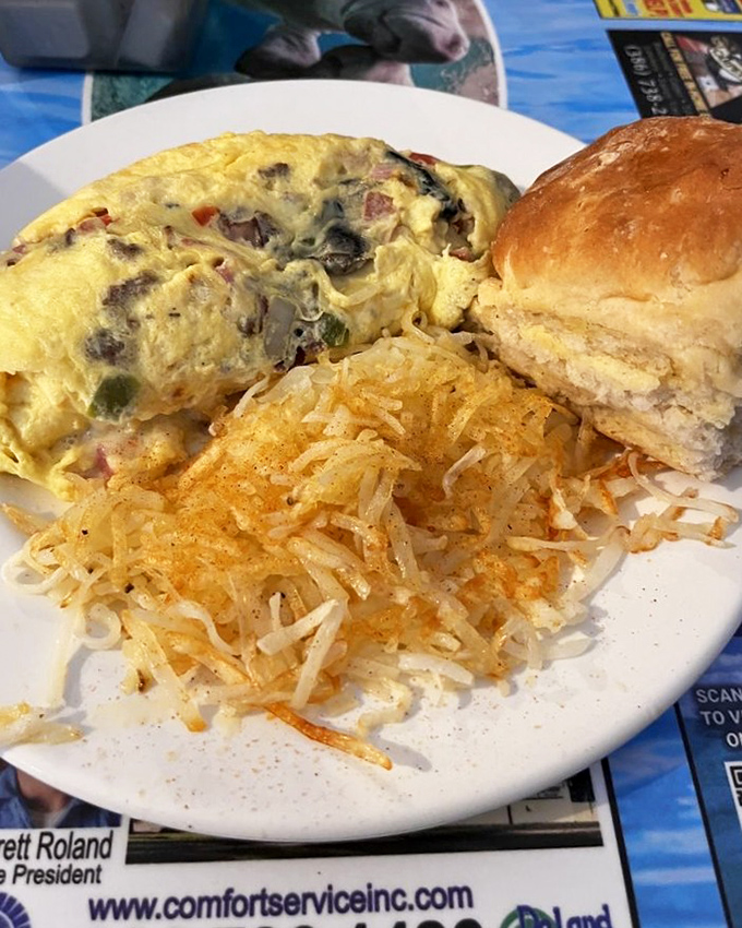 An omelet that's seen more fillings than a dentist's office, paired with hash browns that crackle with each bite.