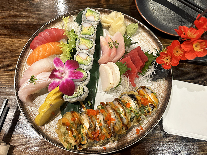 A sushi platter arranged with the care of a jeweler setting precious stones. That purple orchid isn't just garnish&mdash;it's a statement.