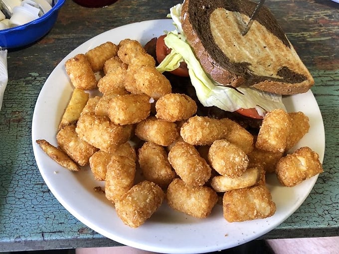 These aren't just any tater tots &ndash; they're golden nuggets of potato perfection escorting a sandwich to its delicious destiny.