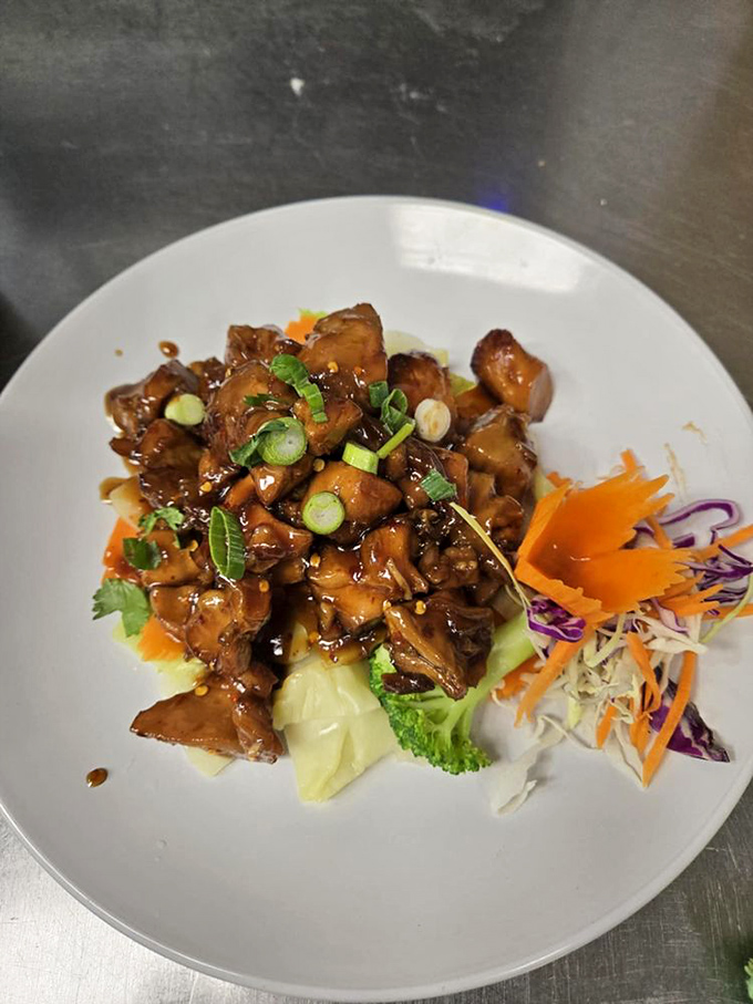 Glistening chunks of meat in a caramelized sauce with that perfect garnish of green onions. This isn't just stir-fry&mdash;it's edible art with attitude.