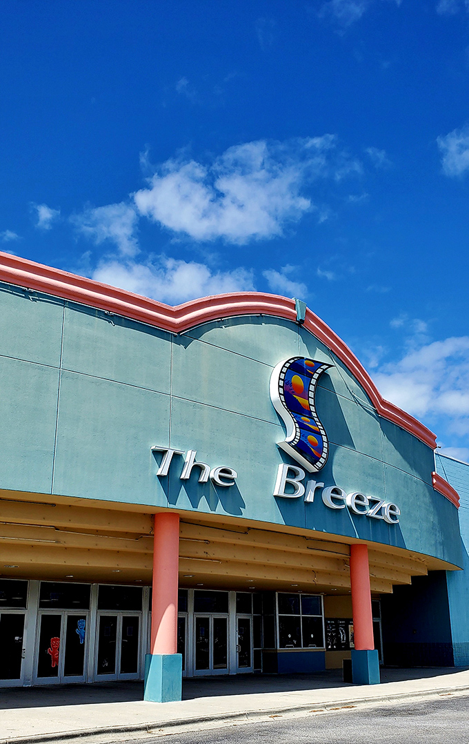 The vibrant red and white restaurant catches golden hour sunlight like it was designed for your Instagram feed. Palm trees included at no extra charge.