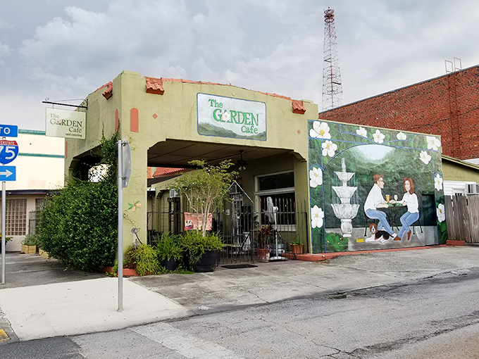 The Garden Cafe's charming mural invites you into a world where lunch isn't rushed and conversations aren't interrupted by notification pings.