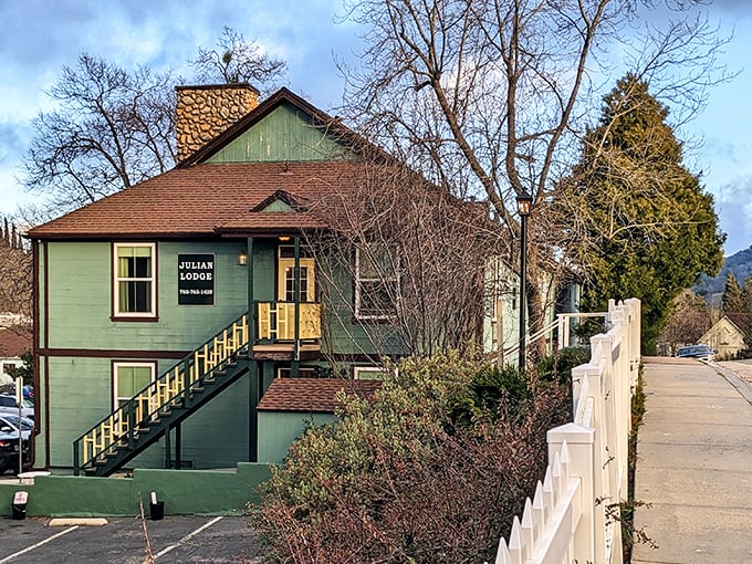 The Julian Lodge's green facade and white picket fence create the perfect mountain getaway that Norman Rockwell never got around to painting.