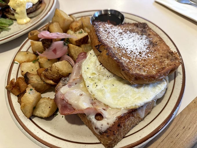 That classic diner breakfast: eggs, ham, and potatoes with those pickled onions adding a pop of color and tang that elevates everything on the plate.