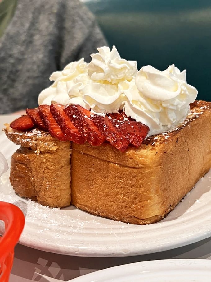 French toast that's crossed the line from breakfast to dessert, with strawberries and whipped cream playing supporting roles in this morning drama.