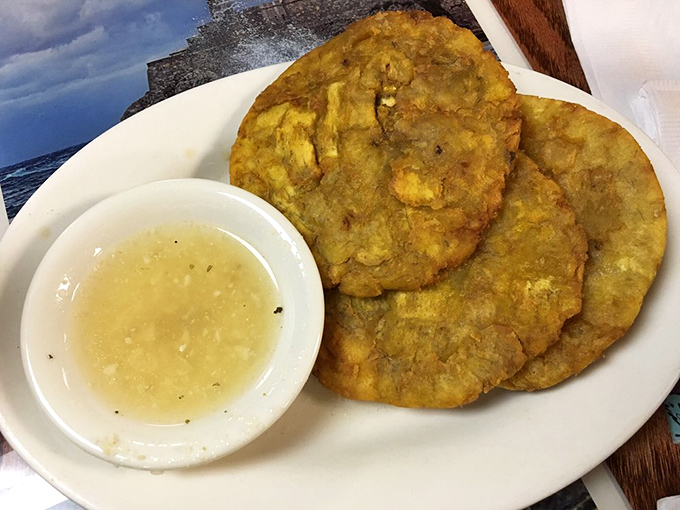 Tostones with their garlic dipping sauce&mdash;proof that sometimes the best things in life are fried twice.