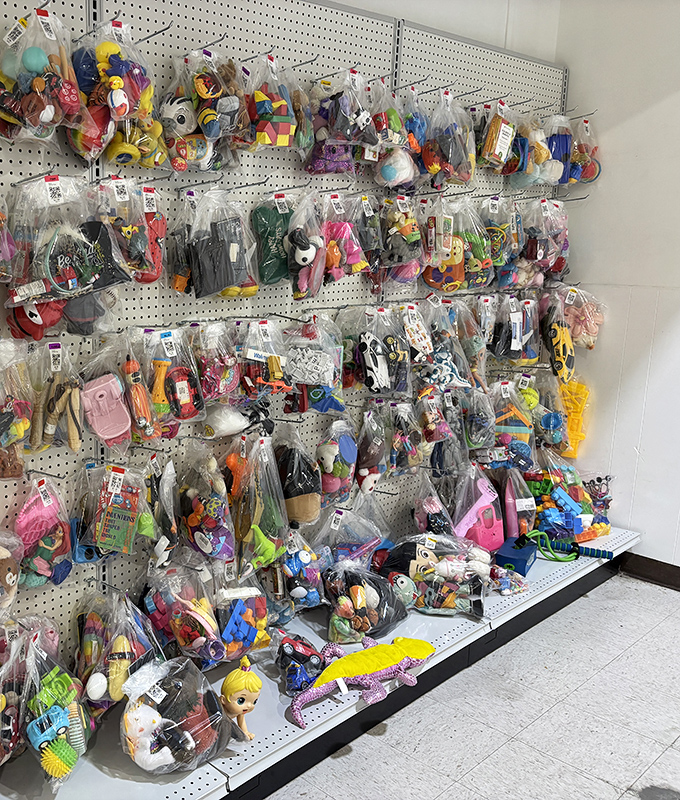 Bagged toys line the walls like a plastic menagerie &ndash; childhood memories sealed in clear plastic, waiting for their next playtime adventure.