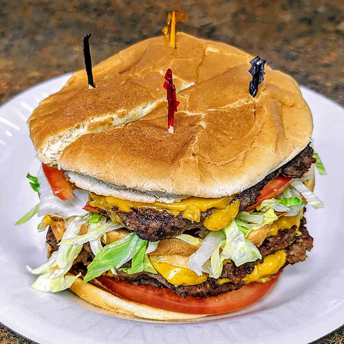 This triple-decker cheeseburger isn't just a meal, it's an architectural achievement. Those colorful toothpicks are holding together a masterpiece.