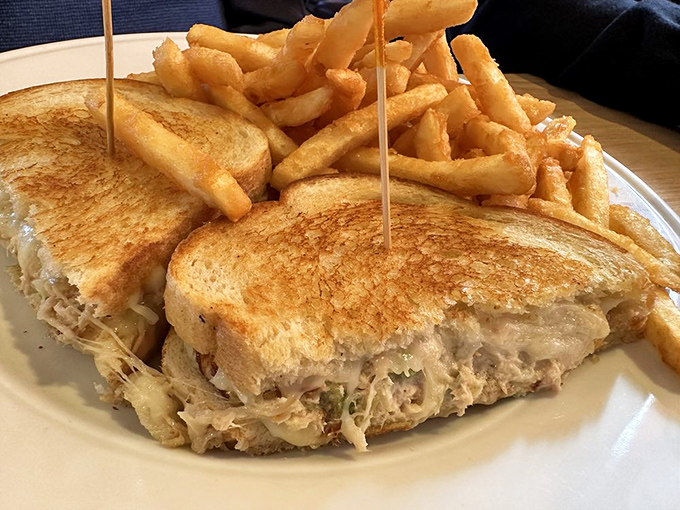 The humble tuna melt, elevated to art form. Perfectly toasted bread cradles a generous filling while golden fries stand at attention.
