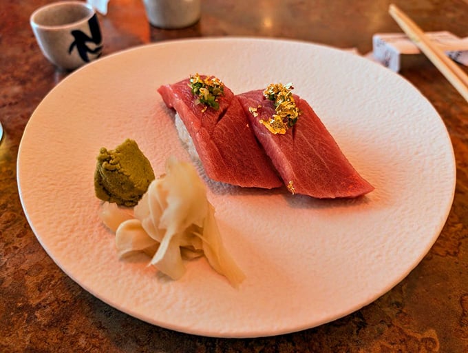 Tuna nigiri topped with gold flakes &ndash; because sometimes Tuesday deserves a touch of luxury that doesn't require a second mortgage.