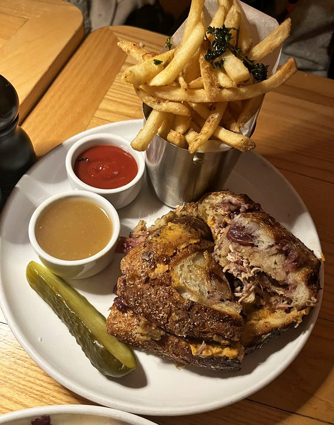 This sandwich isn't messing around—layers of tender meat, melted cheese, and that pickle standing guard like a tasty sentinel.