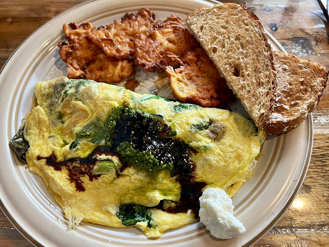 This isn't just an omelet&mdash;it's a vegetable delivery system disguised as breakfast indulgence, with toast standing by for necessary mopping duties. 