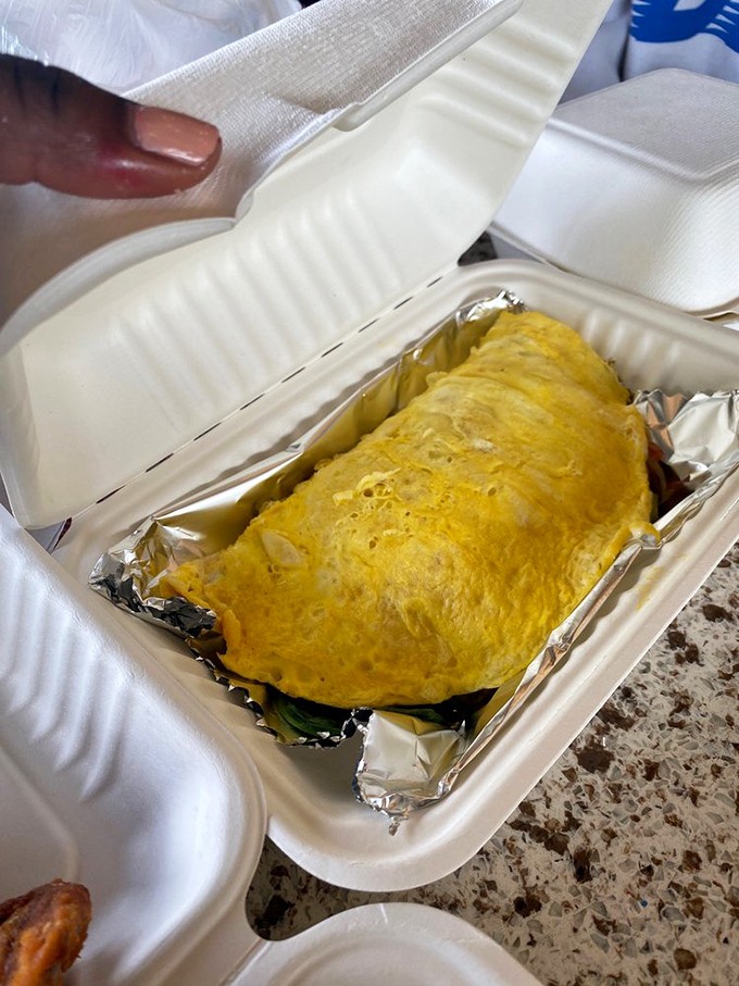 An omelet so fluffy it practically hovers above the container. Breakfast gold wrapped in a yellow cloud.