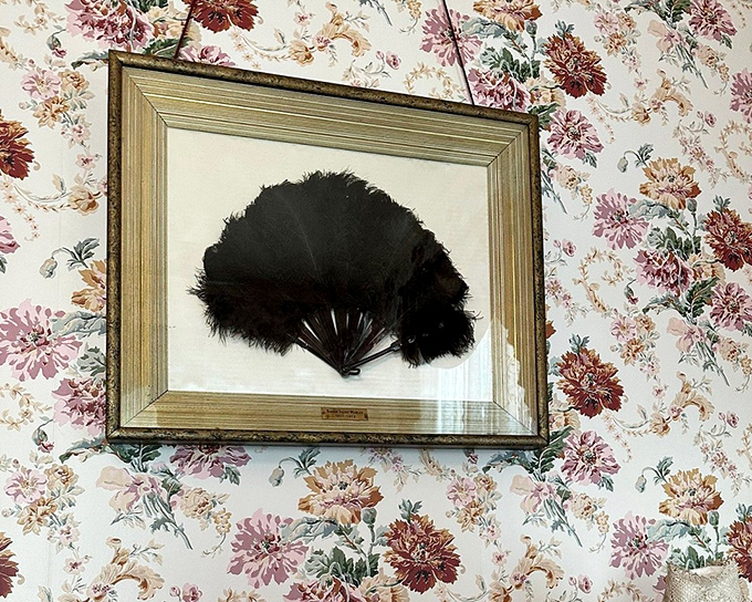 A Victorian lady's feather fan&mdash;the 19th-century equivalent of air conditioning with the added bonus of flirtatious possibilities behind floral wallpaper.