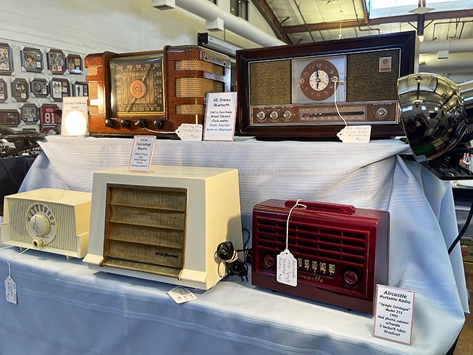 Vintage radios stand at attention, their dials and knobs silently testifying to an era when families gathered around for evening entertainment.