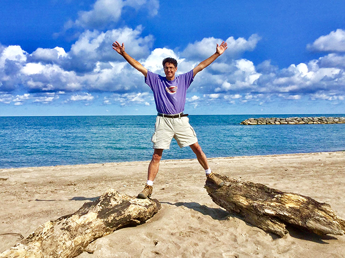 Arms outstretched in the universal "I'm at the beach!" pose that's been perfected by vacation dads since the invention of the camera.