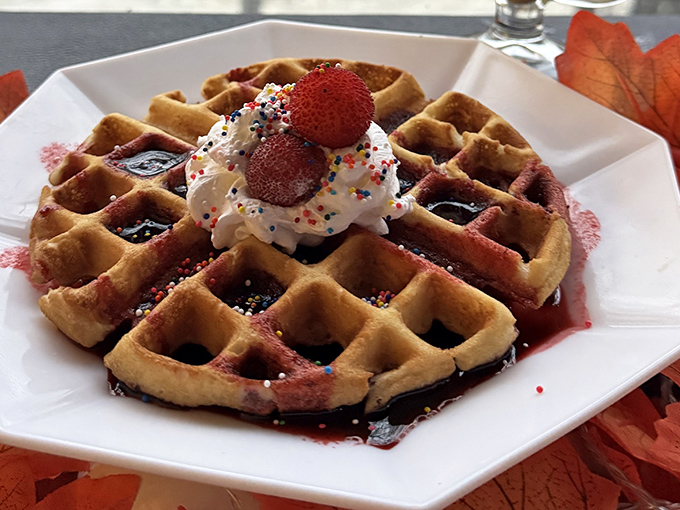 Breakfast becomes dessert with this berry-topped waffle masterpiece. The whipped cream and sprinkles say "celebration" even if it's just Tuesday morning.