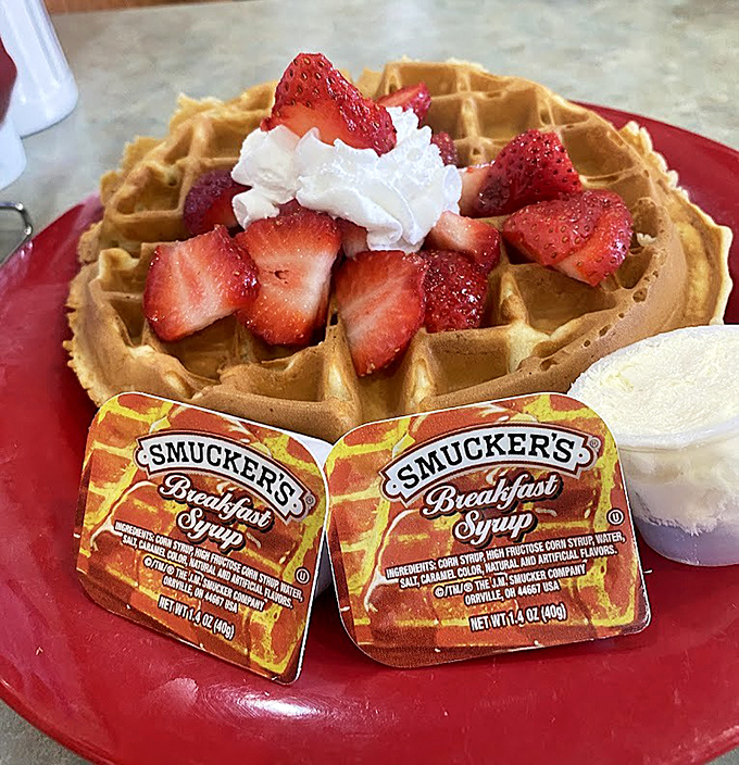 A golden waffle crowned with fresh strawberries and whipped cream&mdash;breakfast that boldly crosses into dessert territory without apology.