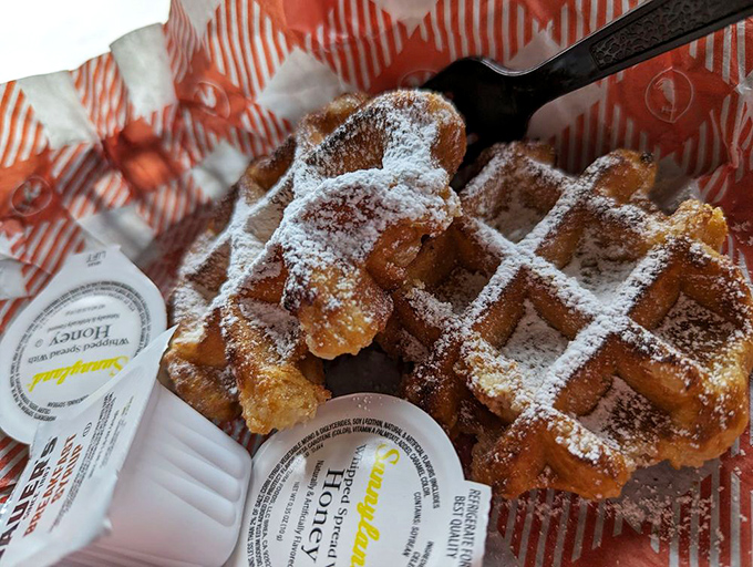 Belgian waffles dusted with powdered sugar &ndash; because sometimes you need sweetness after the heat storm.