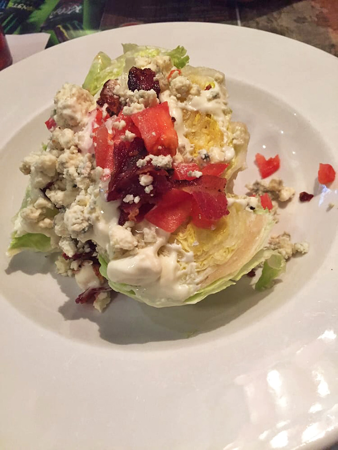 The wedge salad offers a refreshing crunch beneath layers of bacon, tomato, and blue cheese&mdash;proof that vegetables can be indulgent too.