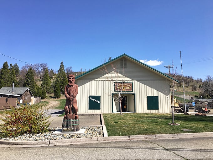 The Weed Historic Lumbertown Museum, complete with carved lumberjack sentinel, preserves the story of when timber, not tourism, was king.