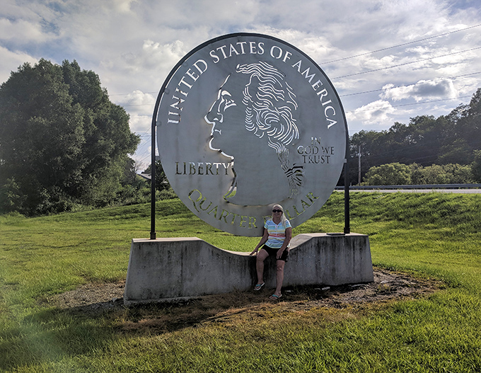 Taking a load off at the base of American currency. The concrete pedestal doubles as the perfect resting spot for weary travelers.