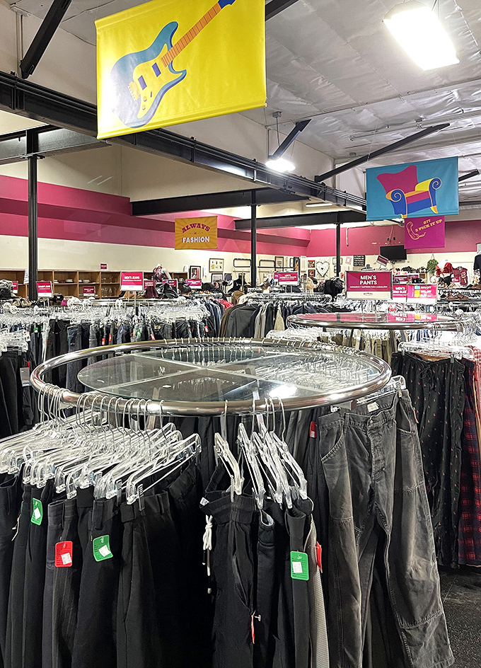 The circular racks create a thrifter's racetrack where finding that perfect pair of jeans feels like winning the fashion lottery.