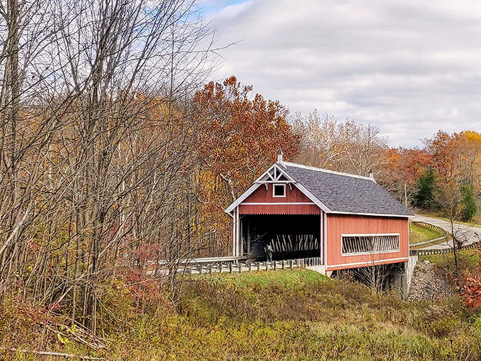 Fall foliage creates the perfect backdrop for this historic treasure, like nature decided to throw a colorful party just for the bridge.