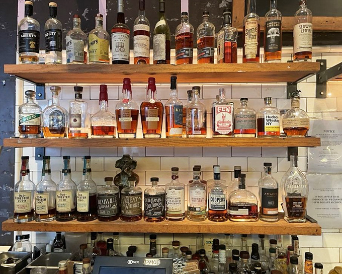 Not just a bar but a whiskey library – shelves stocked with amber treasures waiting to complement your smoked meat adventure.